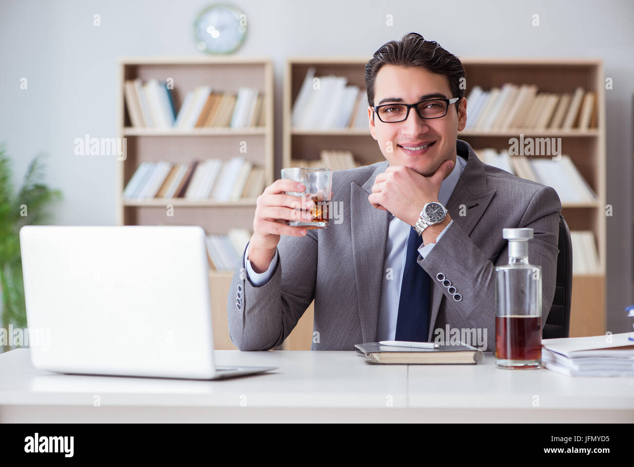 The businessman drinking in the office Stock Photo - Alamy