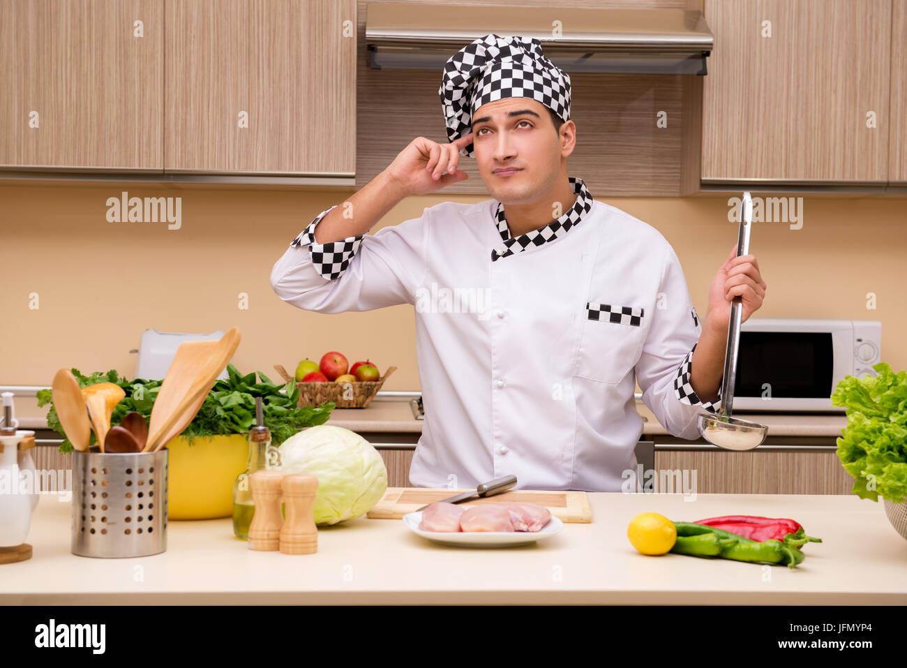 The young chef working in the kitchen Stock Photo - Alamy