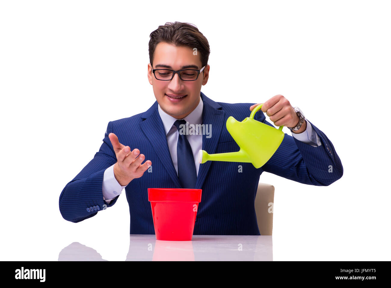 The businessman with watering can isolated on white Stock Photo - Alamy
