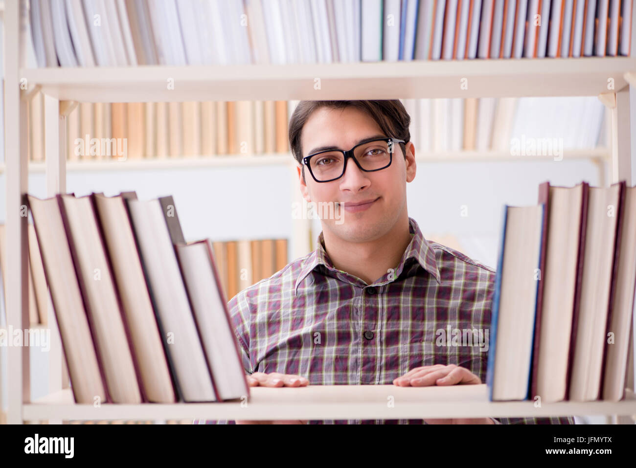 The young student looking for books in college library Stock Photo - Alamy