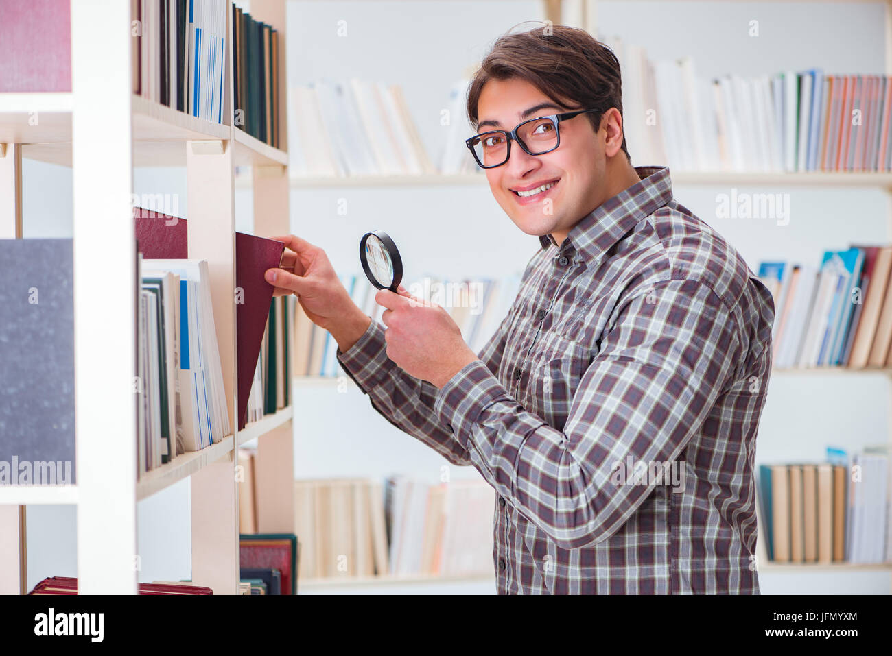 The young student looking for books in college library Stock Photo - Alamy