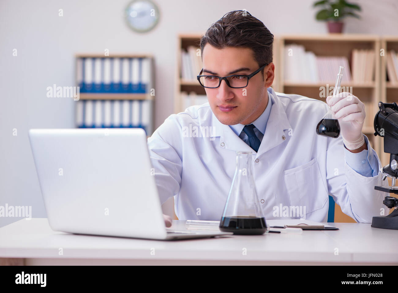 The young lab assistan working in the laboratory Stock Photo - Alamy
