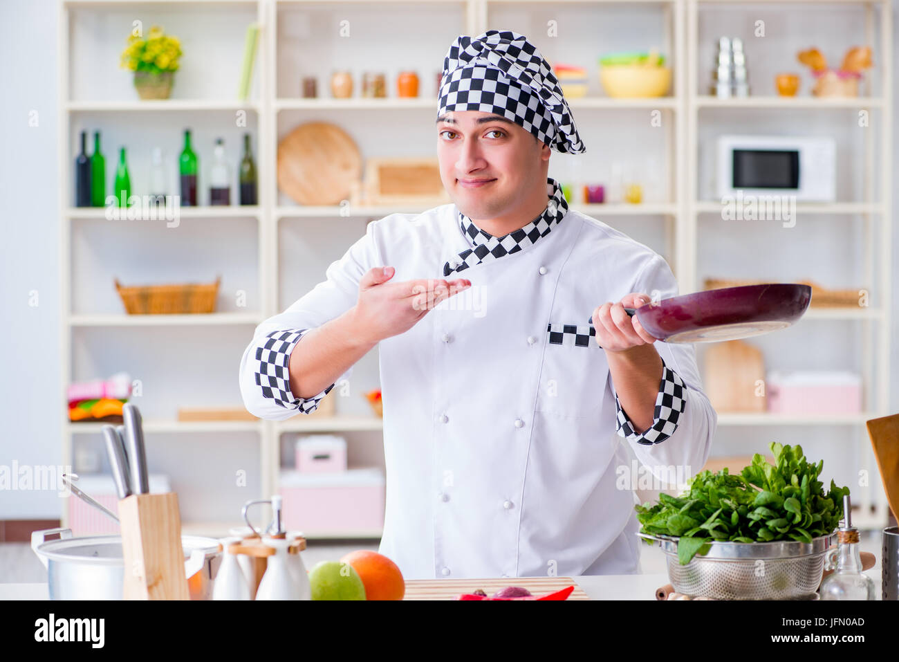 The young male cook working in the kitchen Stock Photo - Alamy