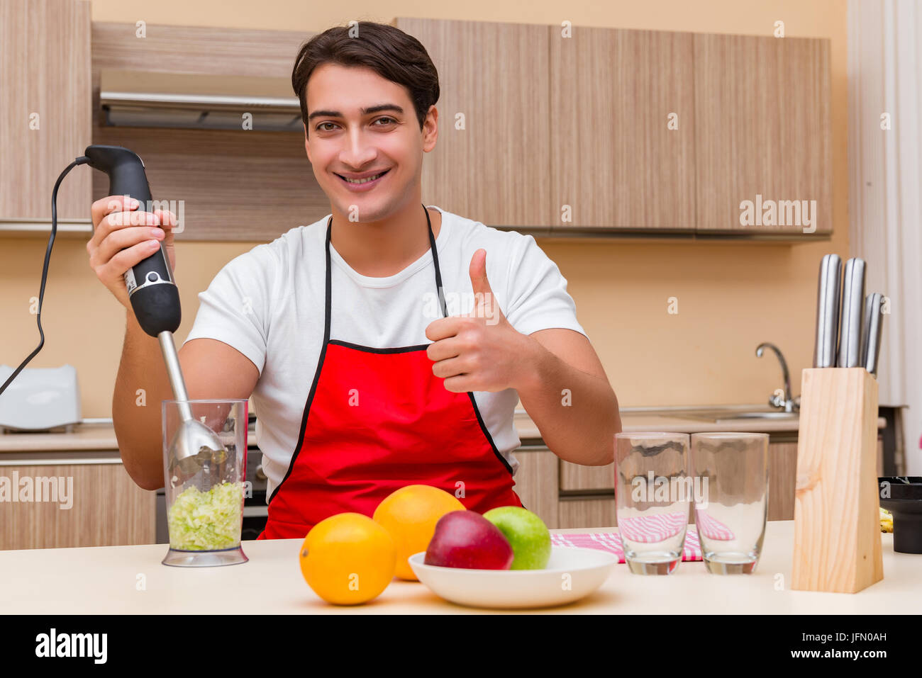 The handsome man working at the kitchen Stock Photo - Alamy