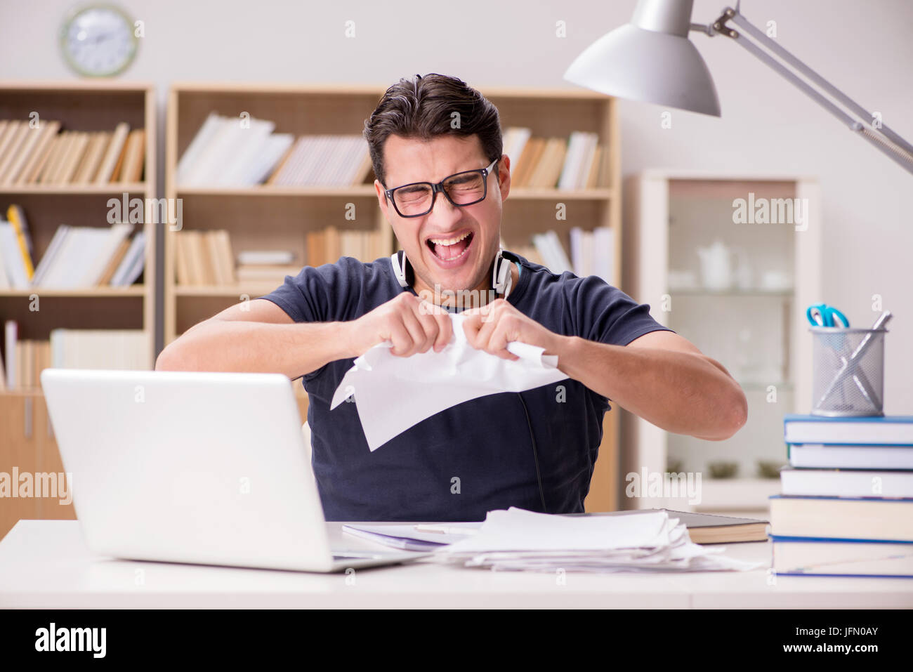 The angry man tearing apart his paperwork due to stress Stock Photo - Alamy