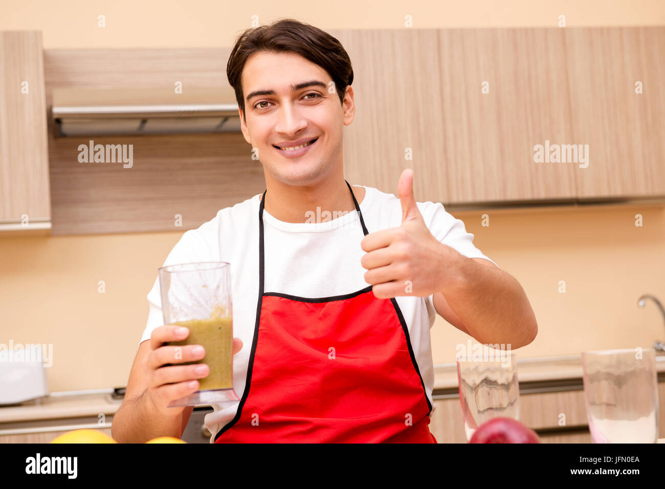 The handsome man working at the kitchen Stock Photo - Alamy