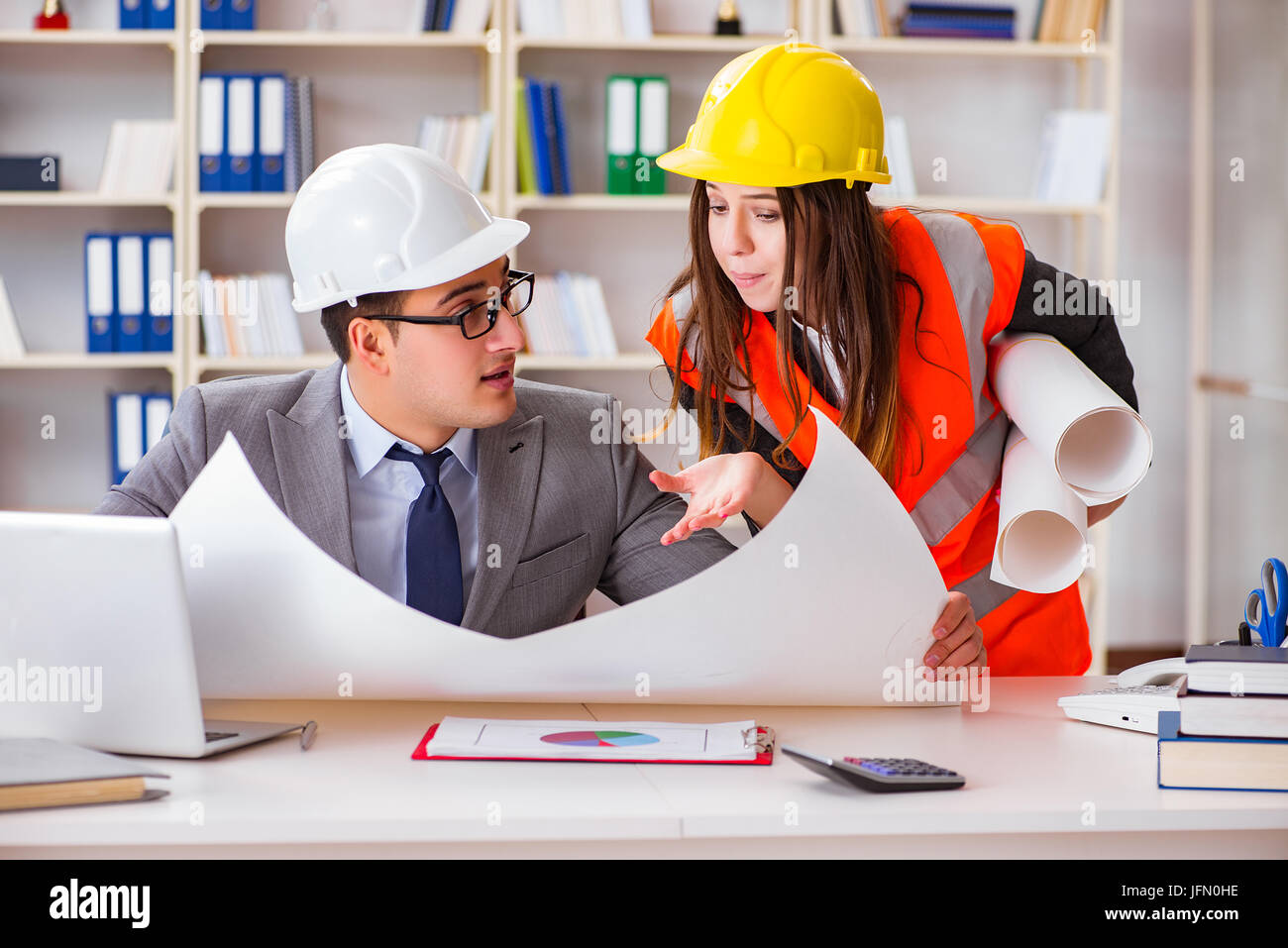 The construction foreman supervisor reviewing drawings Stock Photo - Alamy