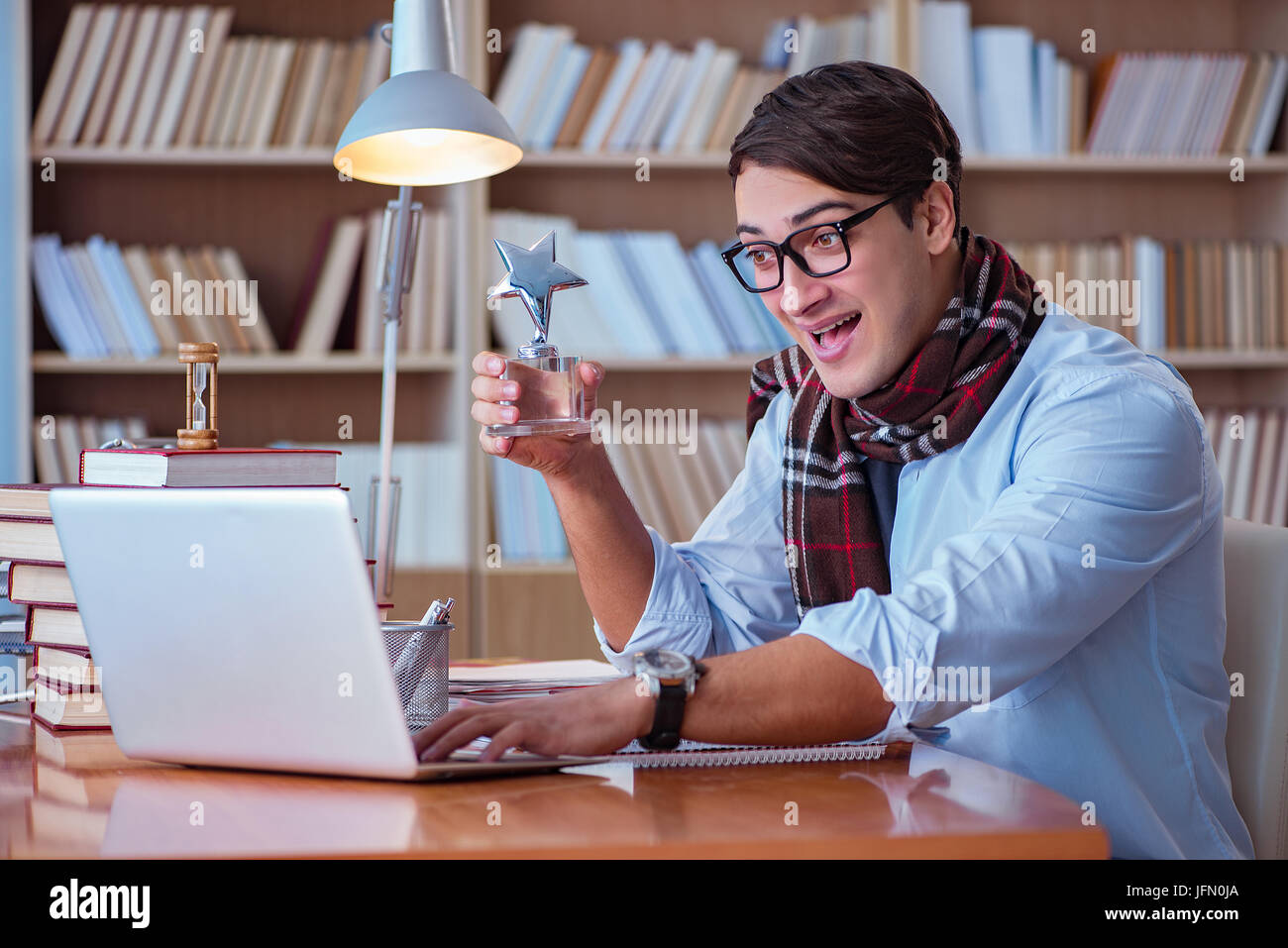 The young book writer writing in library Stock Photo - Alamy
