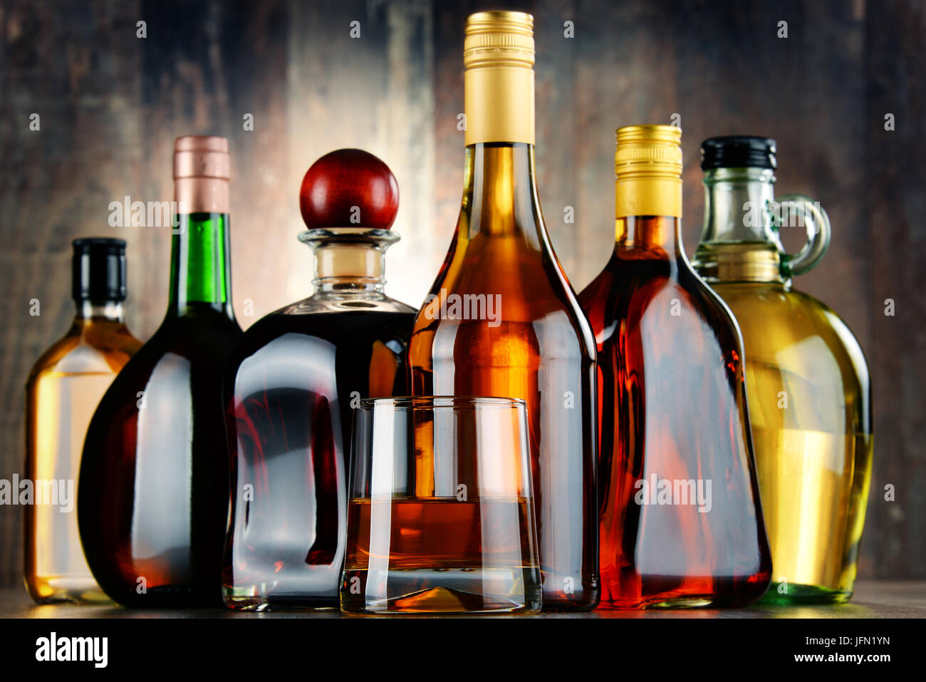 Glass and bottles of assorted alcoholic beverages Stock Photo - Alamy