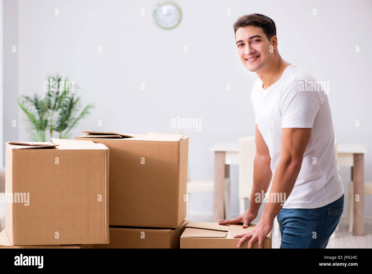 The young man moving boxes at home Stock Photo - Alamy