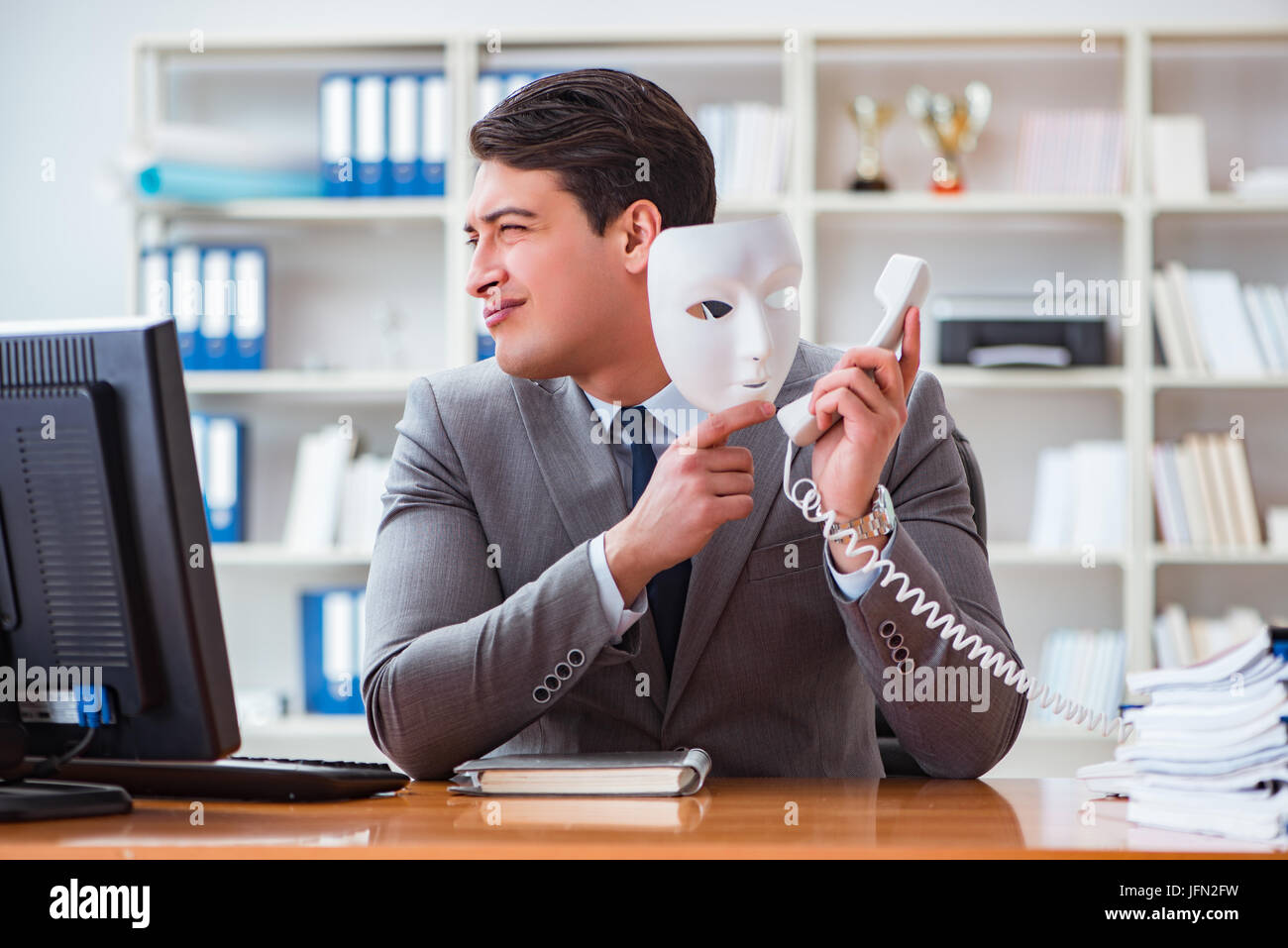 The businessman with mask in office hypocrisy concept Stock Photo - Alamy