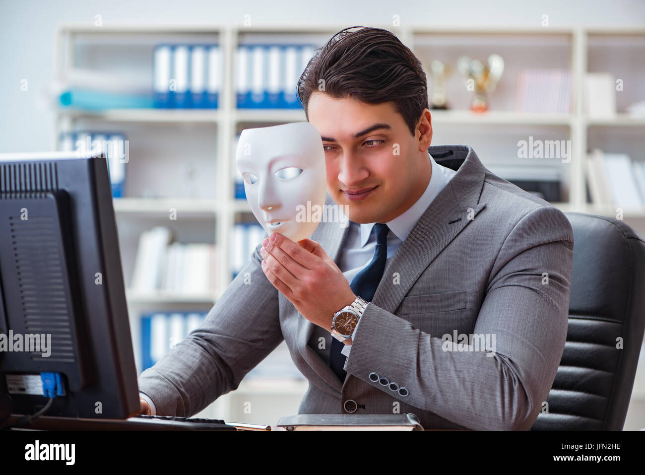 The businessman with mask in office hypocrisy concept Stock Photo - Alamy