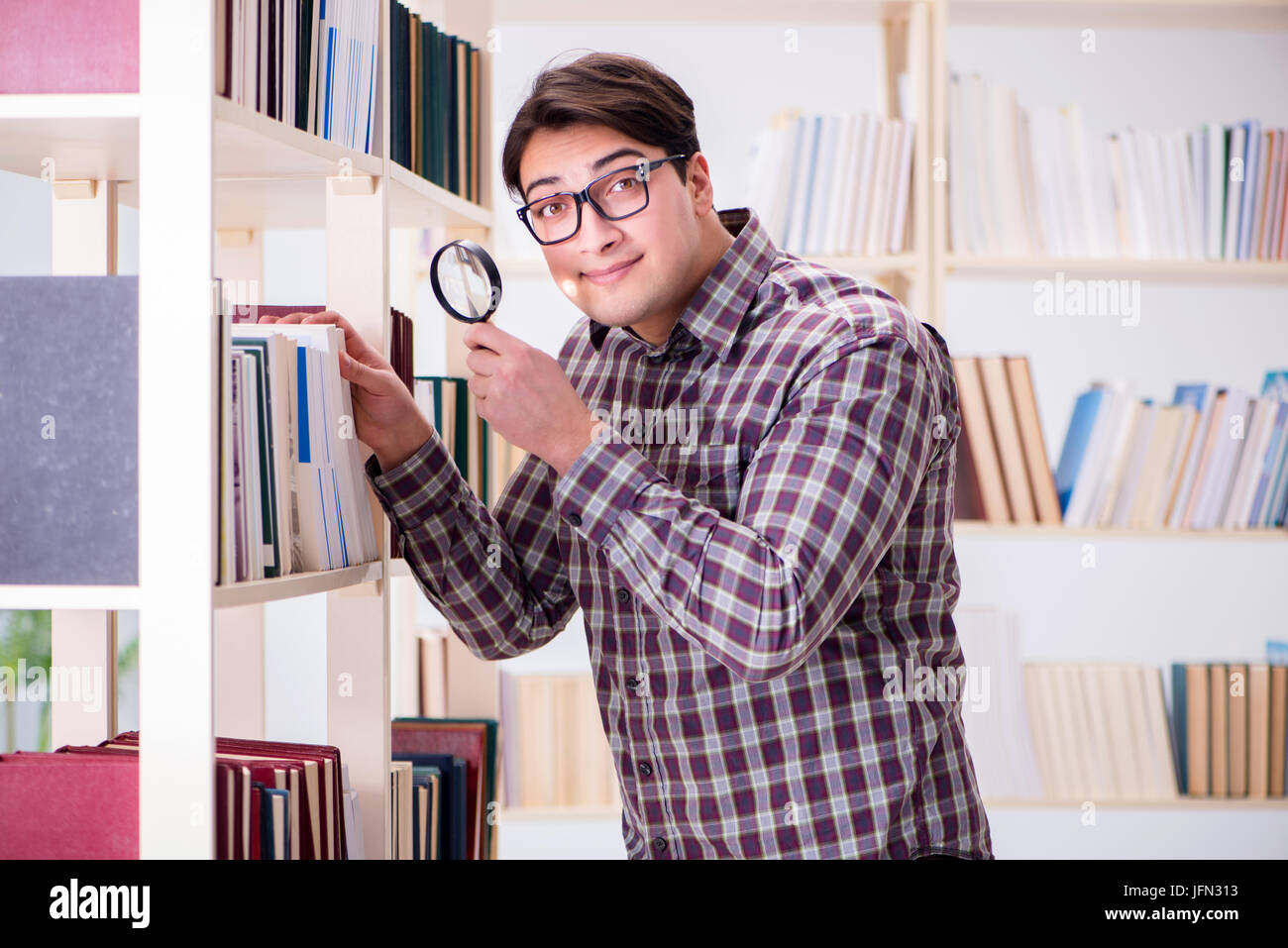 The young student looking for books in college library Stock Photo - Alamy