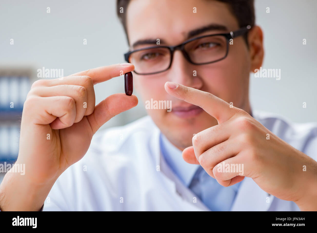 The doctor holding medicines in the lab Stock Photo - Alamy