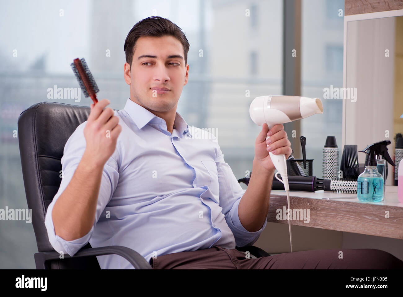 The handsome man in hair salon doing haircut Stock Photo - Alamy