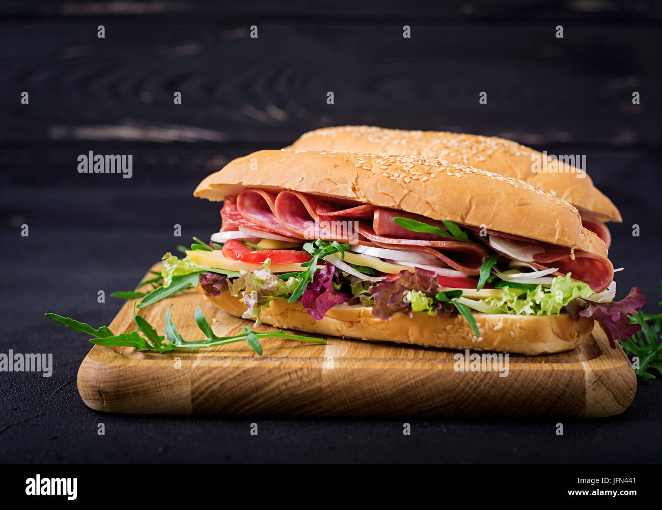Big sandwich with ham, salami, tomato, cucumber and herbs Stock Photo ...