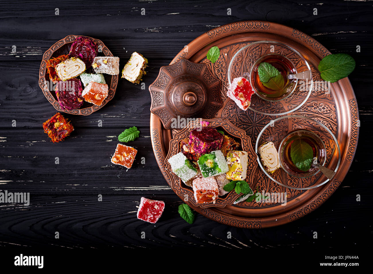 Bowl with various pieces of turkish delight lokum and black tea with ...