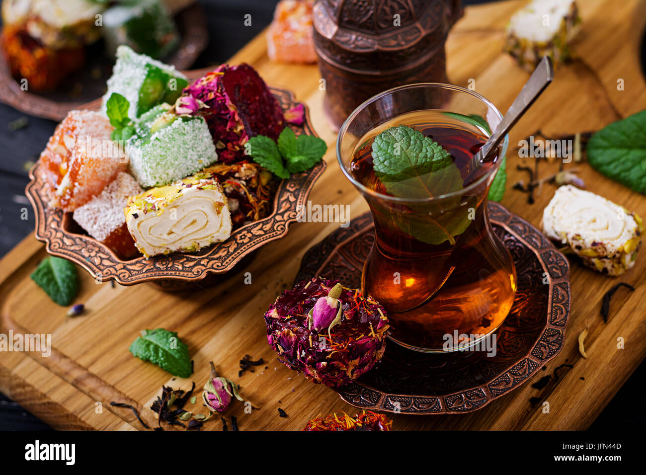 Bowl with various pieces of turkish delight lokum and black tea with ...