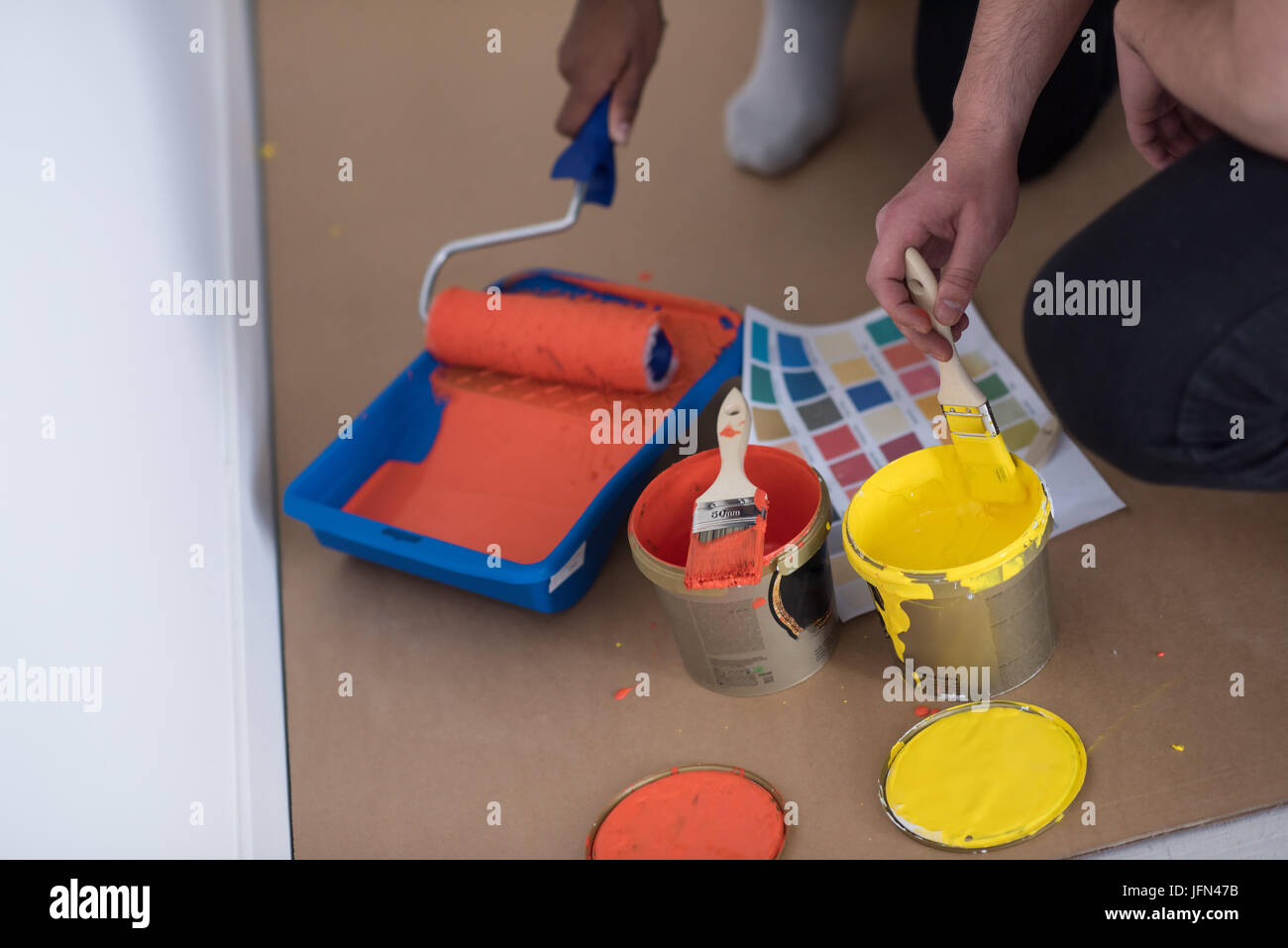 two painters prepare color for painting the wall Stock Photo - Alamy