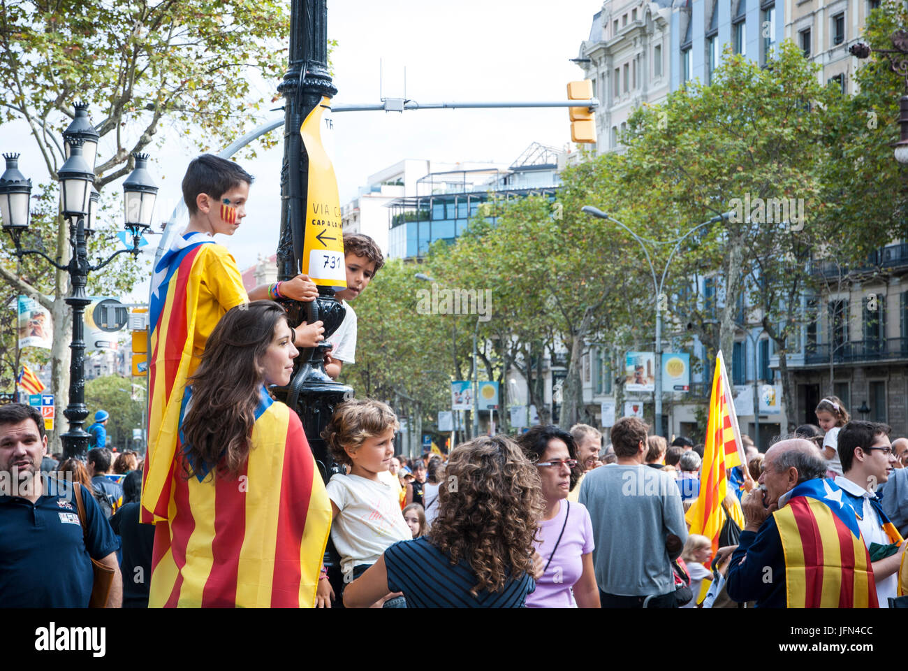BARCELONA, SPAIN - SEPTEMBER 11: Kids waving with flags during "Catalan ...
