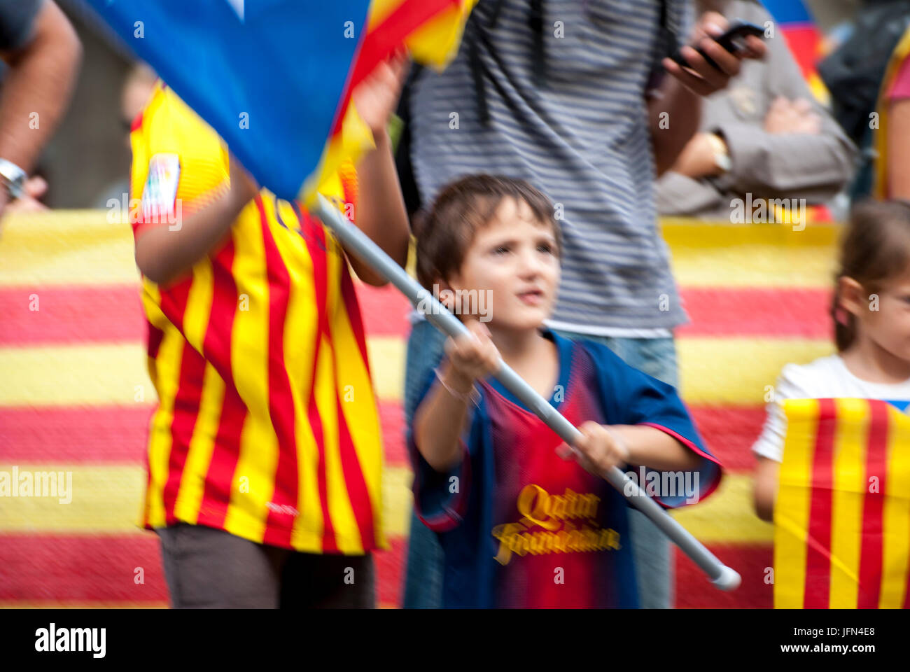 BARCELONA, SPAIN - SEPTEMBER 11: Kids waving with flags during "Catalan ...