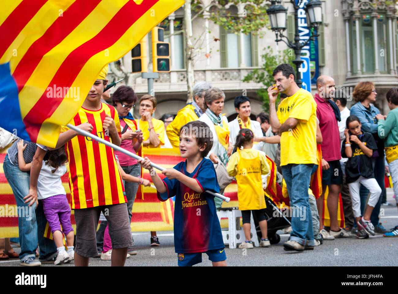 BARCELONA, SPAIN - SEPTEMBER 11: Kids waving with flags during "Catalan ...