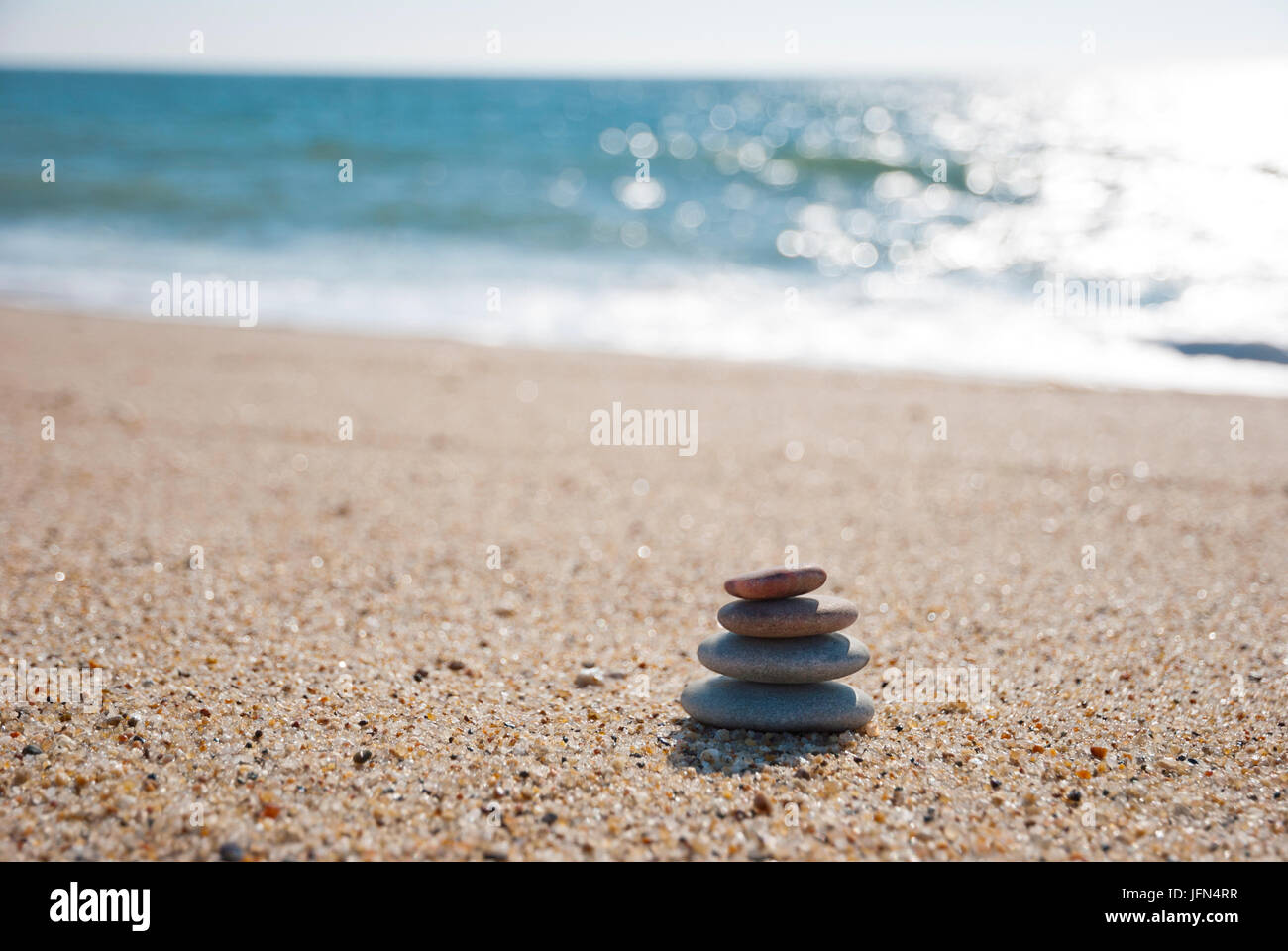 Stack on pebble stones on the beach in the back Stock Photo - Alamy