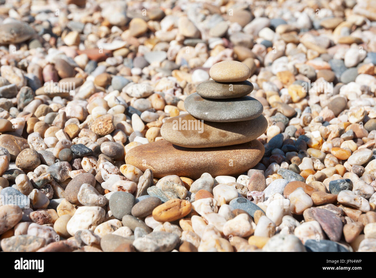 Stack on pebble stones on the beach full of stones Stock Photo - Alamy