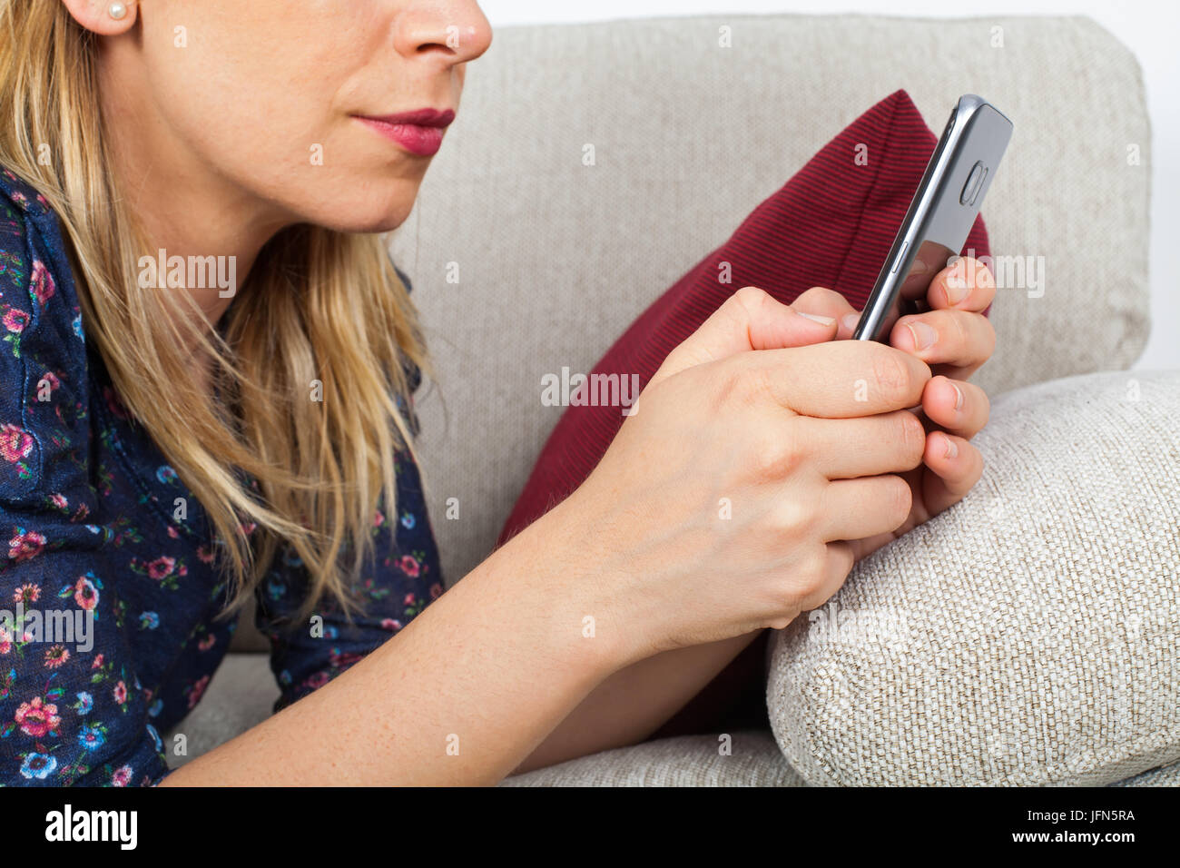 Close up picture of young woman typing on her mobile phone, on the ...