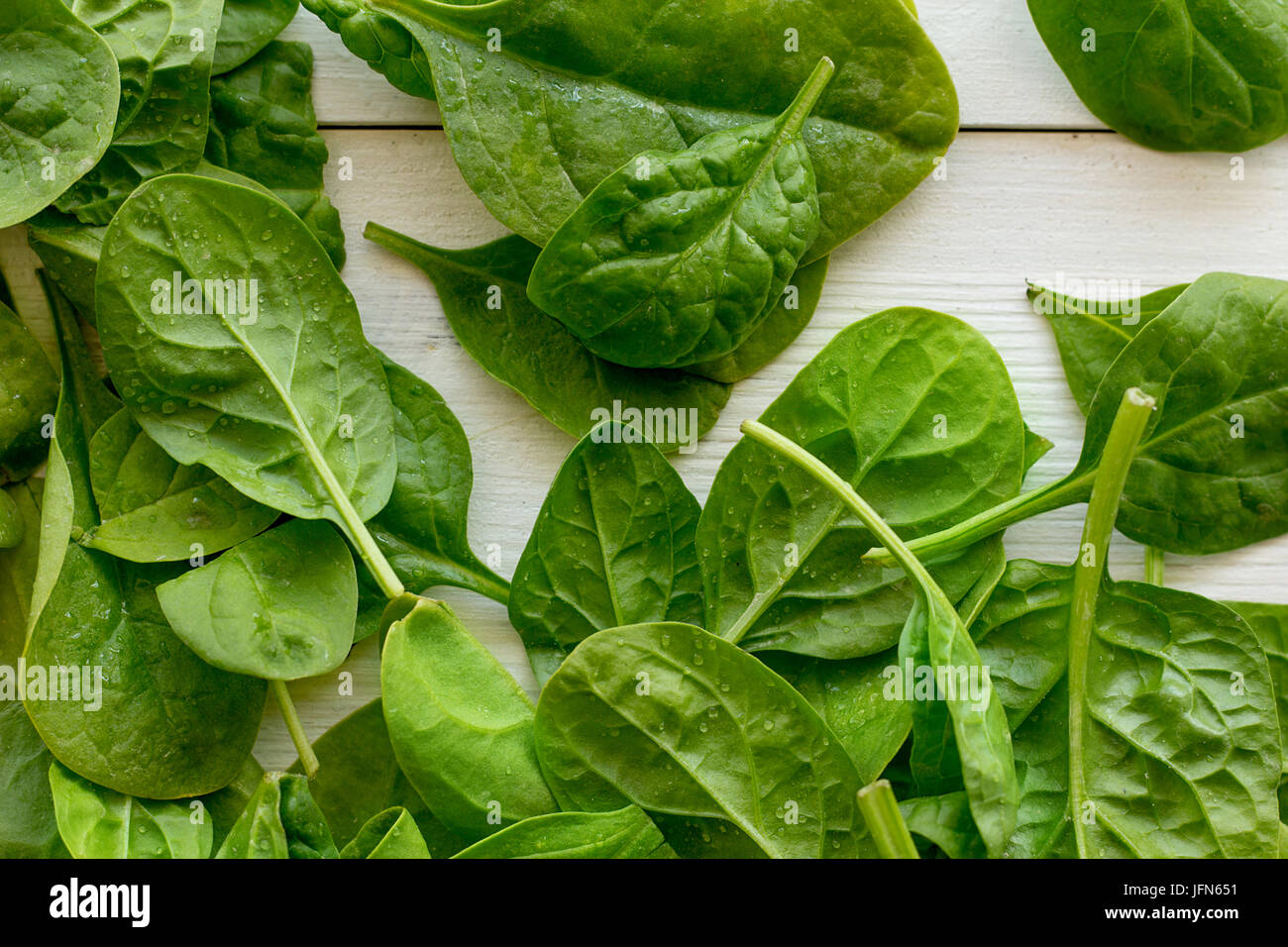 Spinach leaves top view background Stock Photo - Alamy