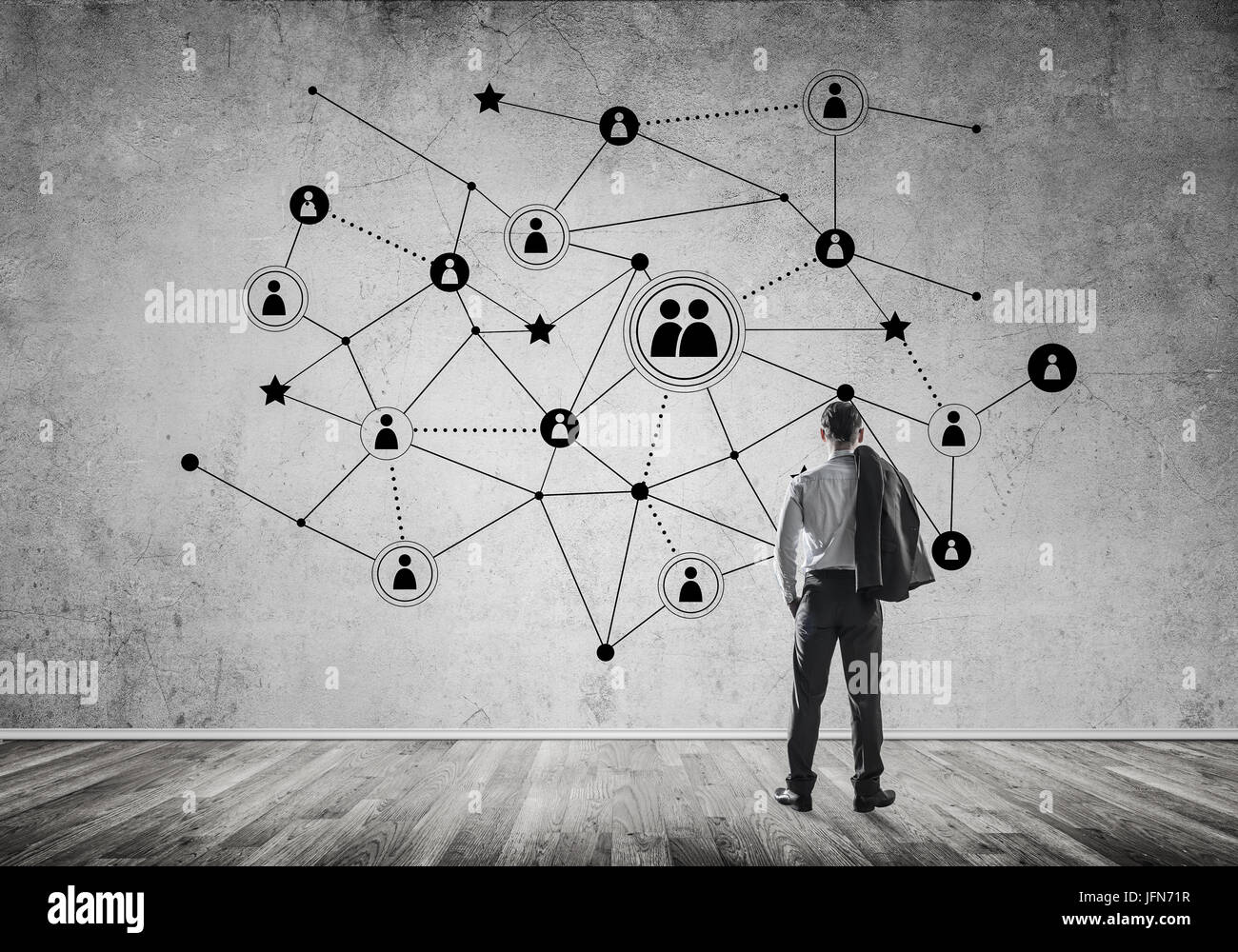 Back view of businessman looking at wall with drawn social connection ...