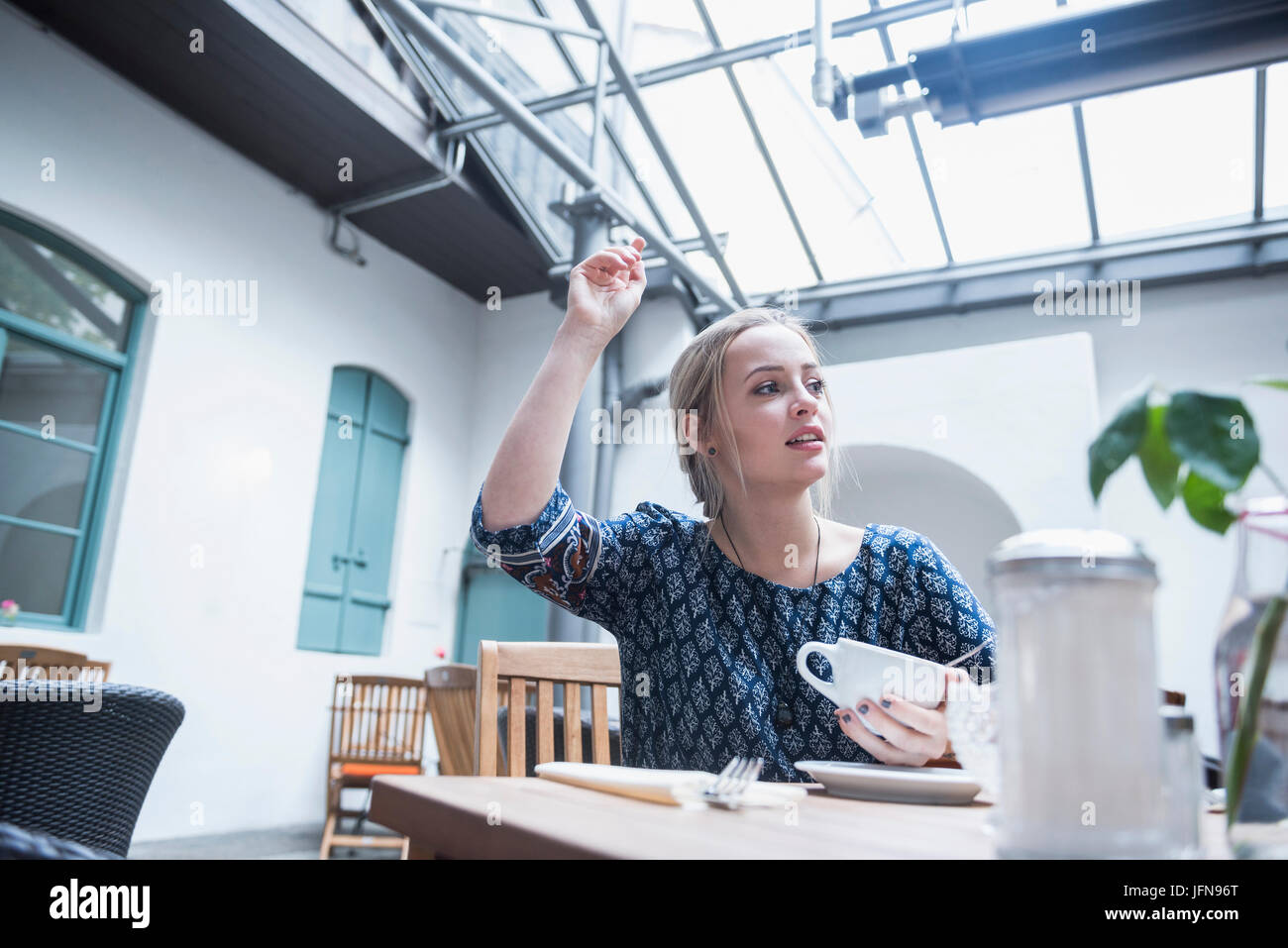Woman calling waiter hi-res stock photography and images - Alamy