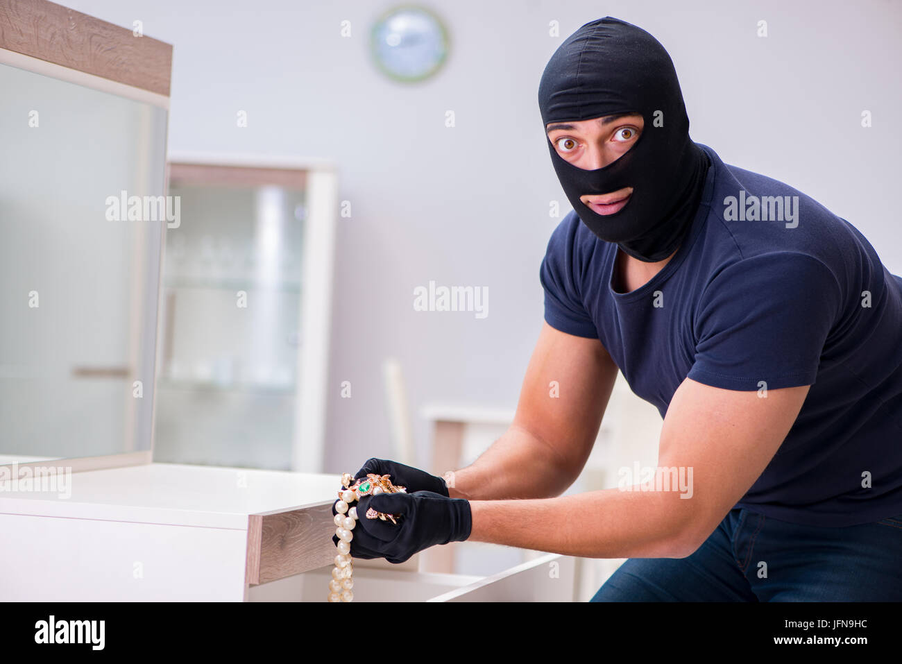 Robber wearing balaclava stealing valuable things Stock Photo - Alamy