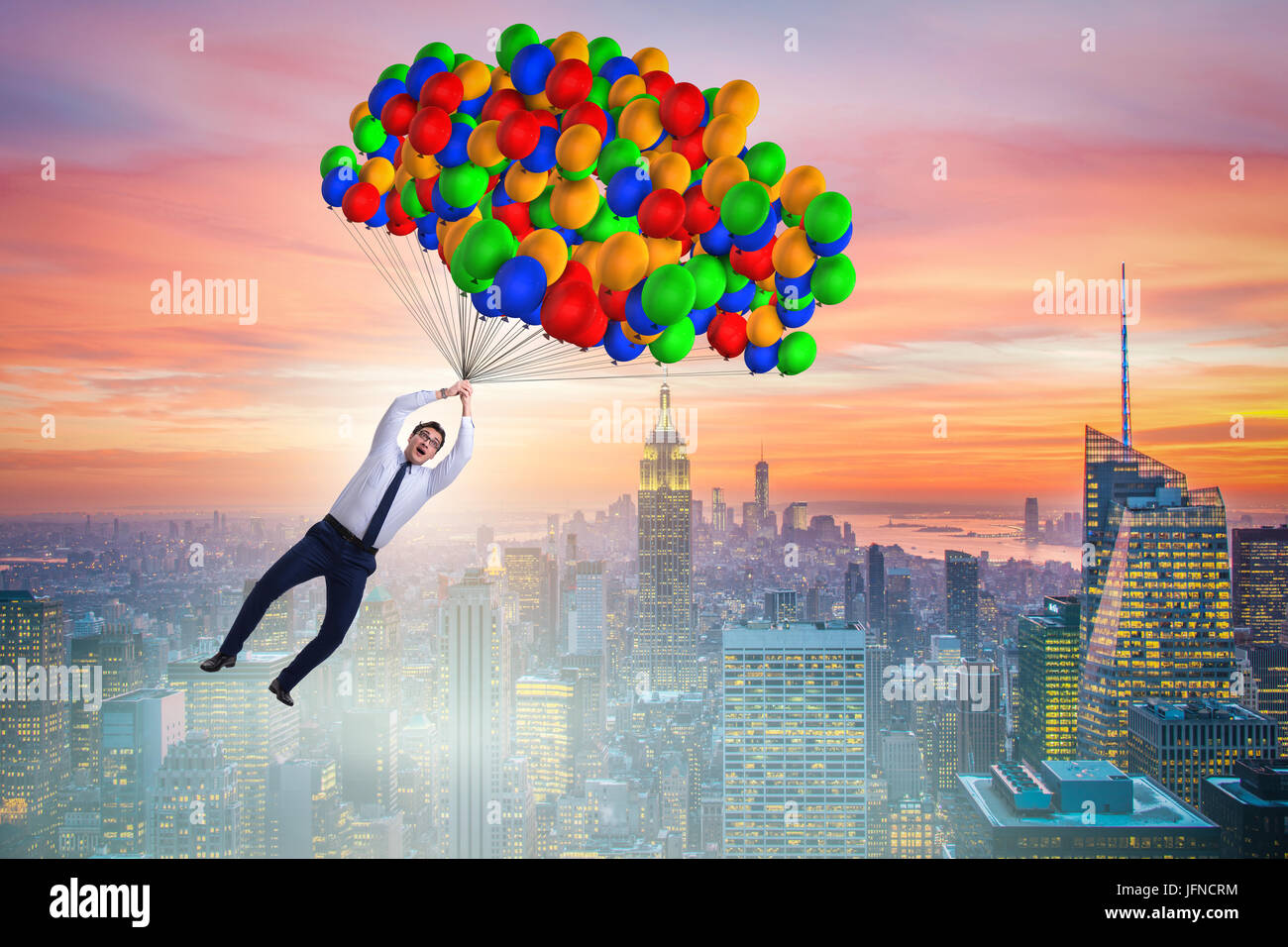 Businessman flying on balloons in challenge concept Stock Photo - Alamy