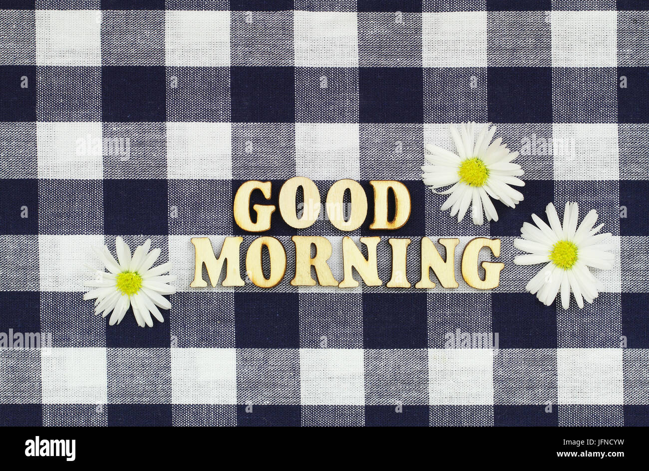 Good morning written with wooden letters on blue and white checkered ...