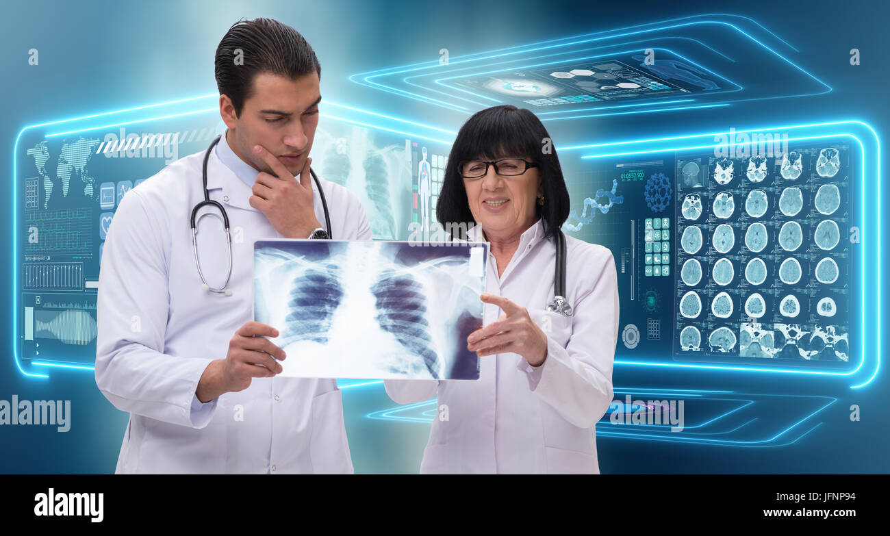 Two doctors looking at x-ray image Stock Photo - Alamy