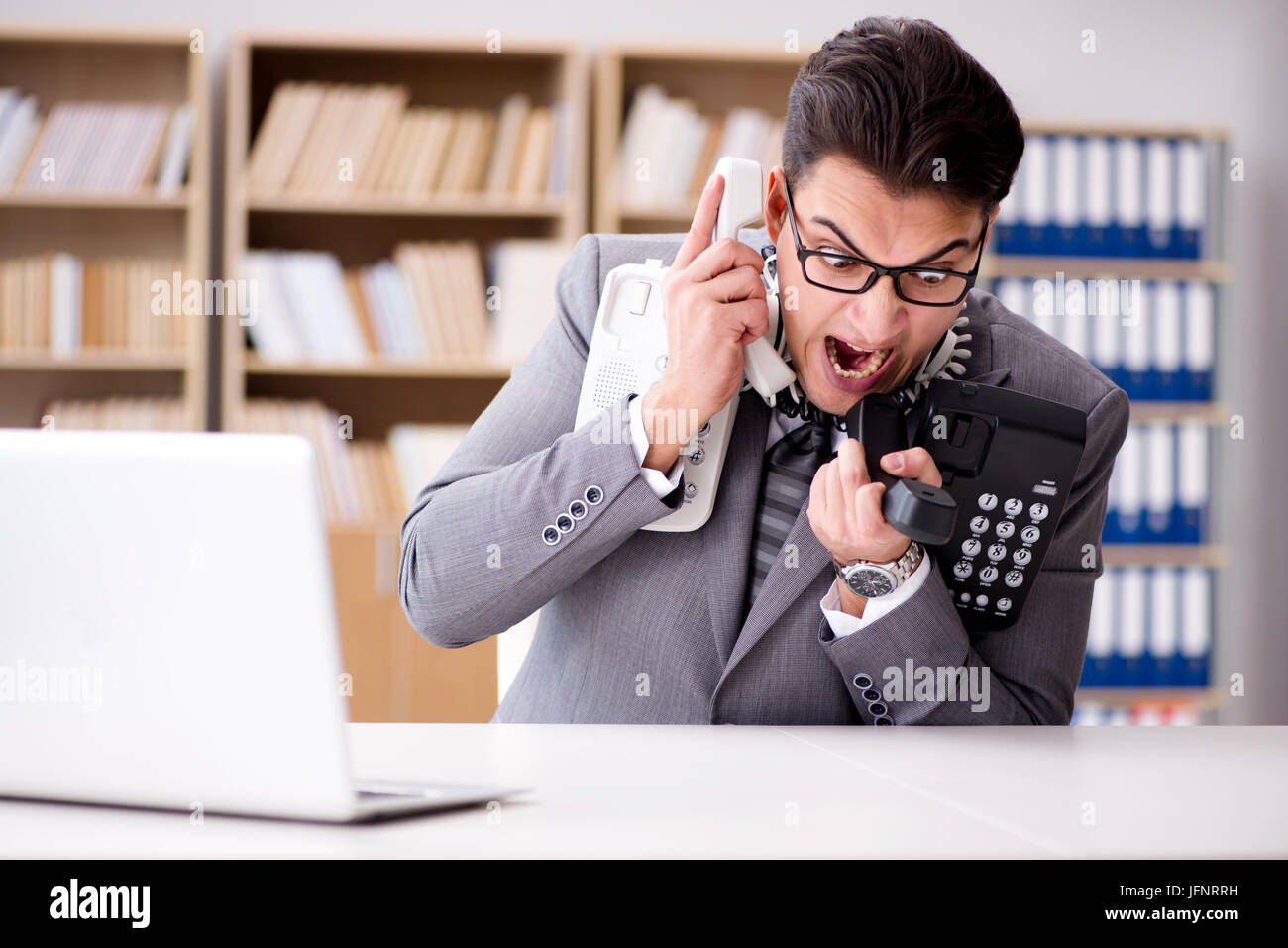 Angry helpdesk operator yelling in office Stock Photo - Alamy