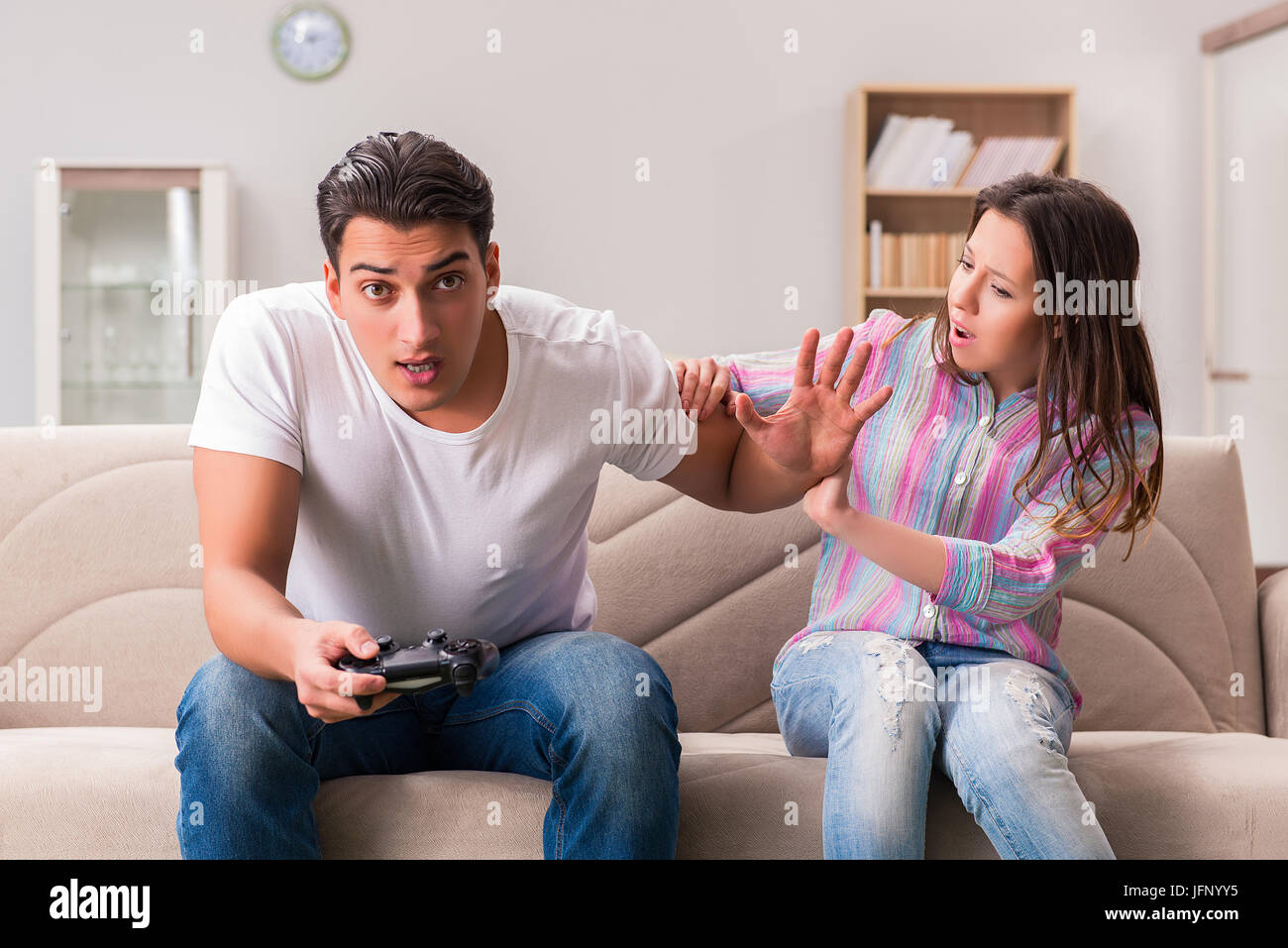 Young family suffering from computer games addiction Stock Photo - Alamy