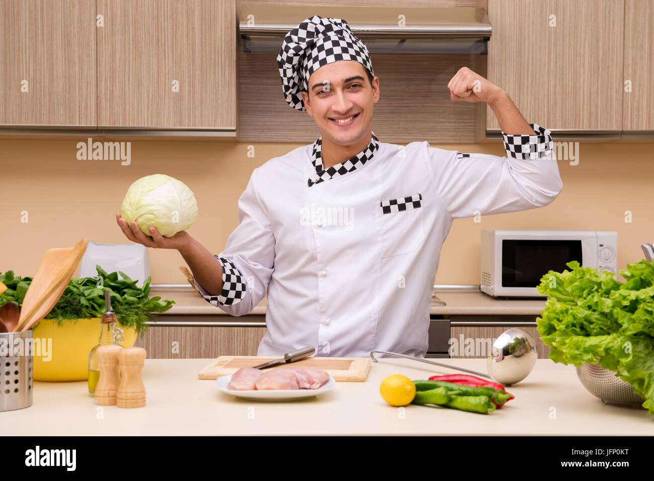 Young chef working in the kitchen Stock Photo - Alamy
