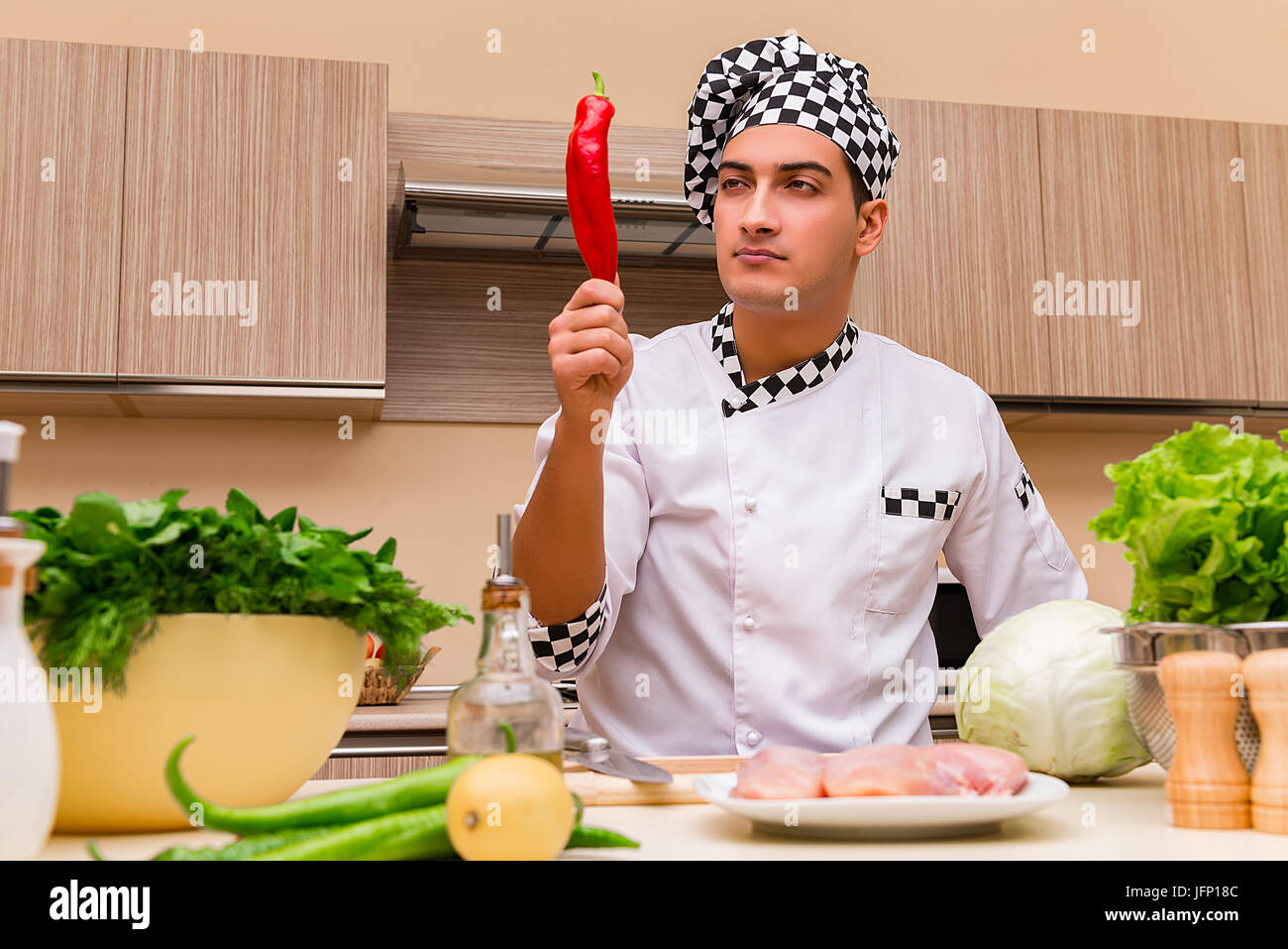 Young chef working in the kitchen Stock Photo - Alamy
