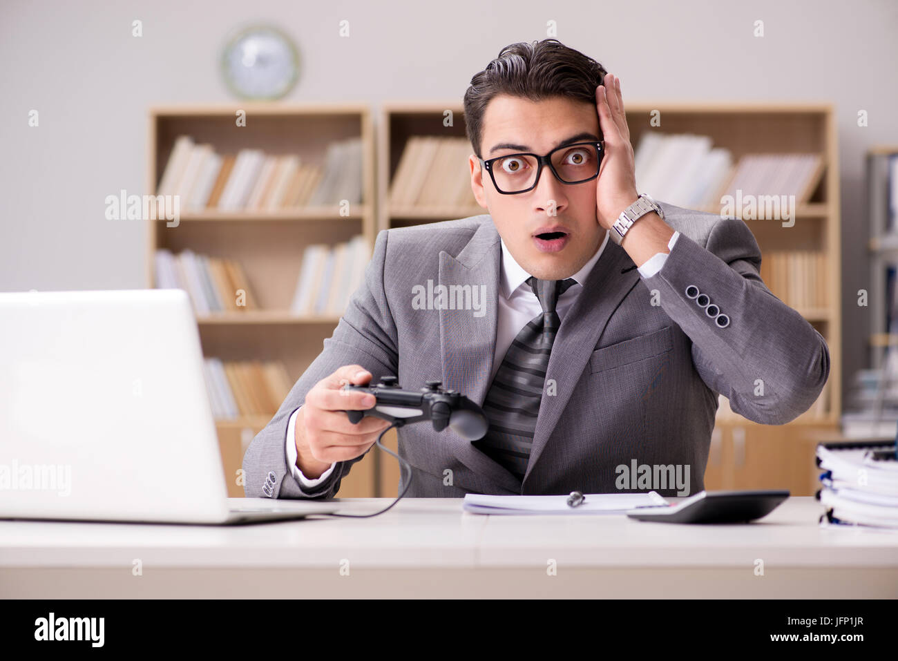 Businessman playing computer games at work office Stock Photo - Alamy