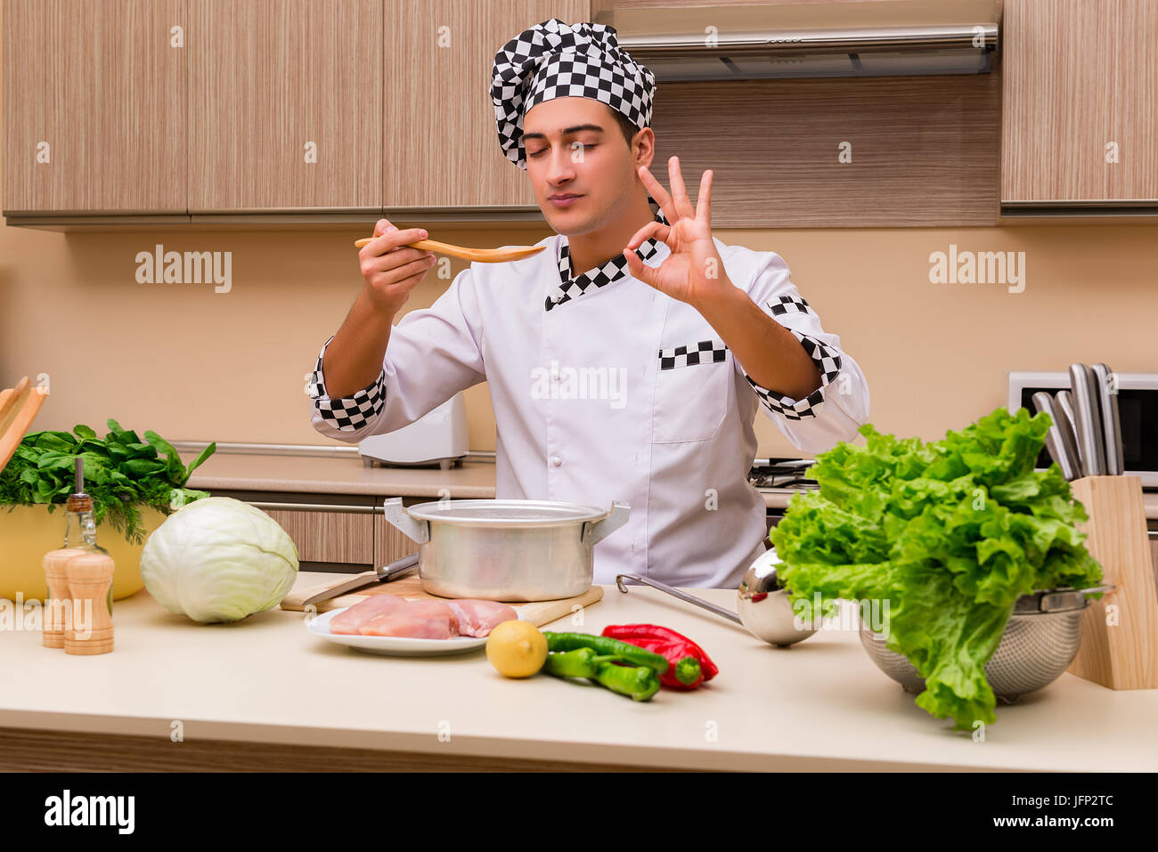 Young chef working in the kitchen Stock Photo - Alamy