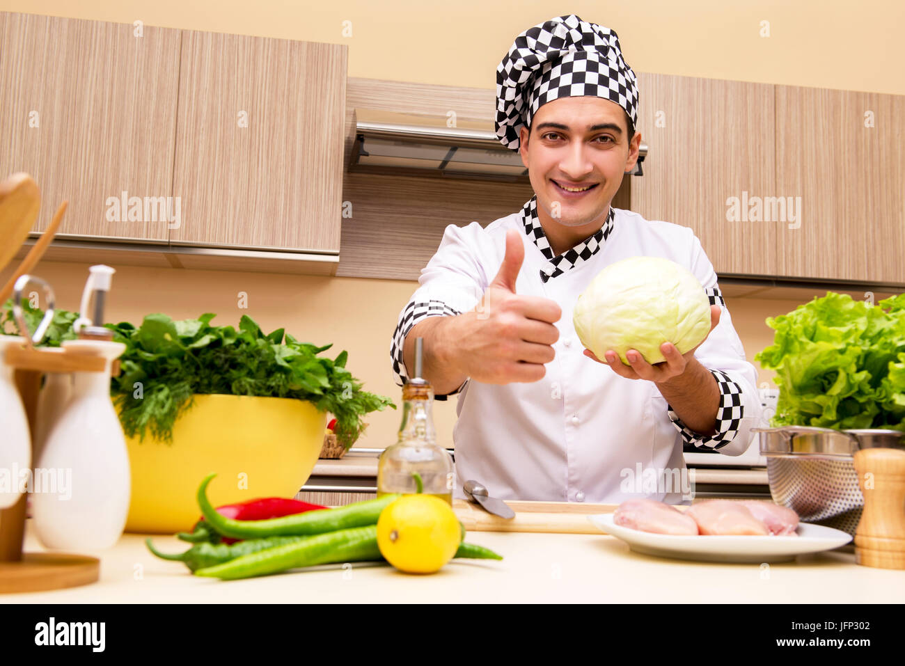Young chef working in the kitchen Stock Photo - Alamy