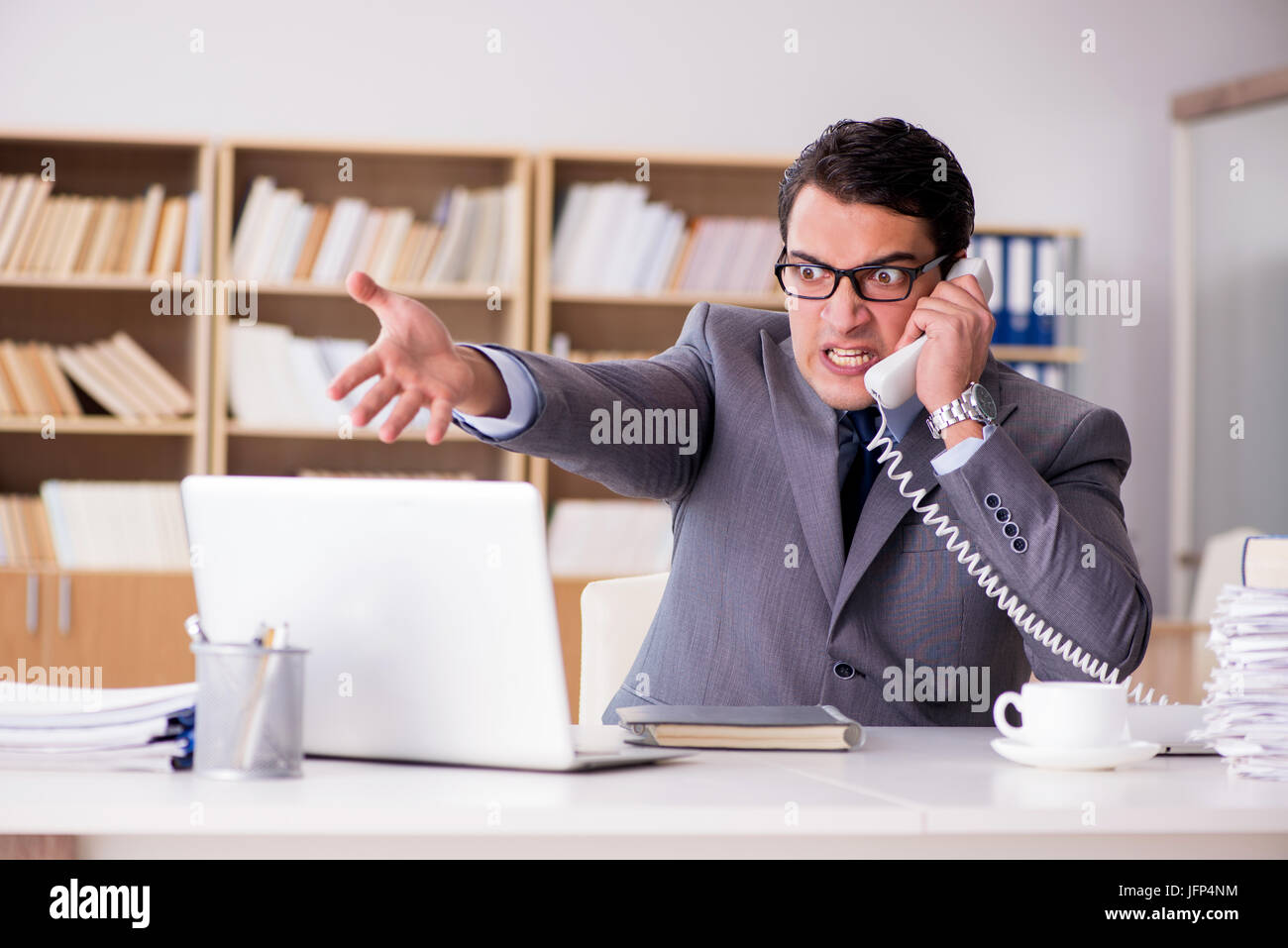 The angry businessman working in the office Stock Photo - Alamy