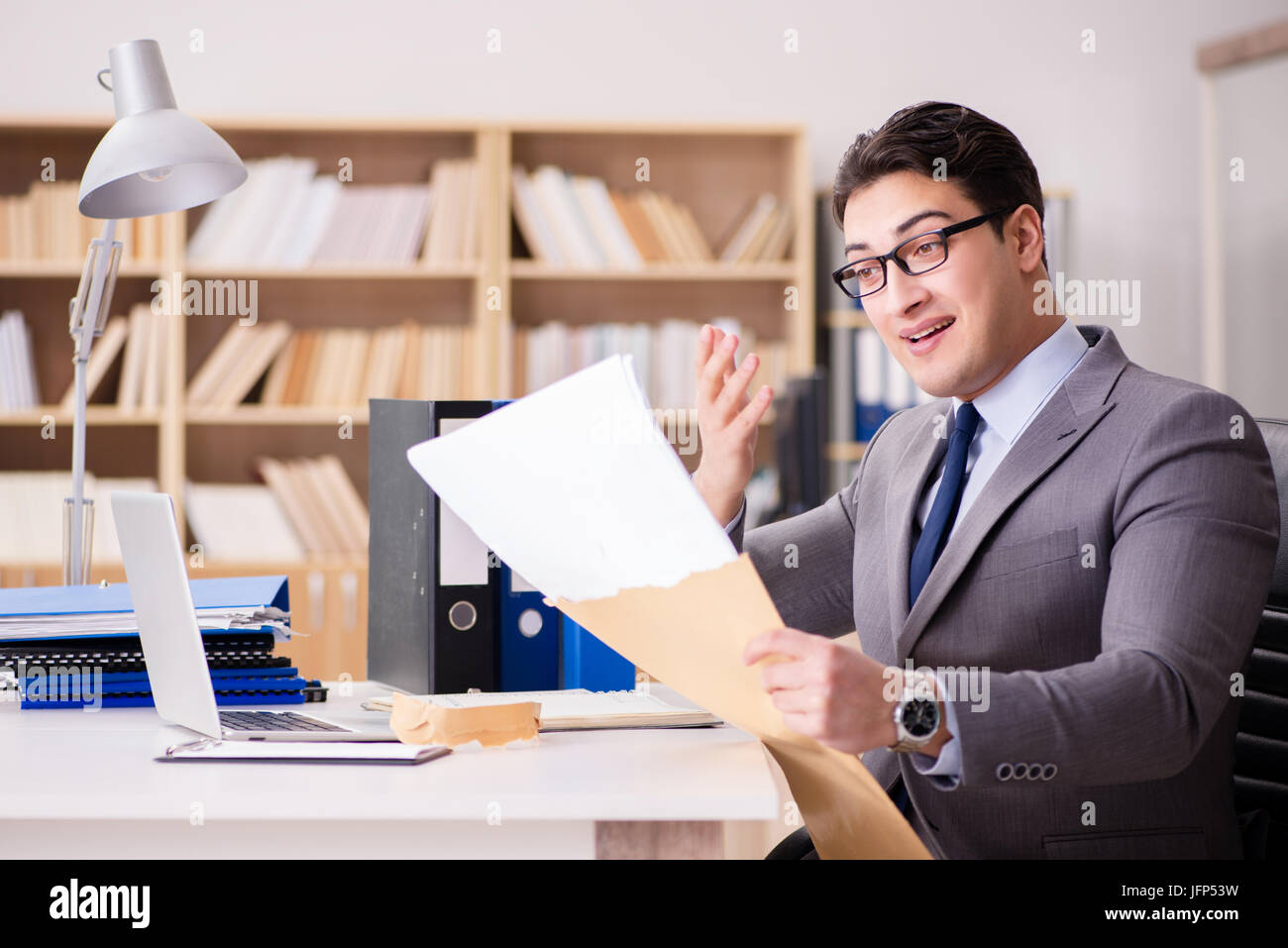 The businessman receiving letter in the office Stock Photo - Alamy