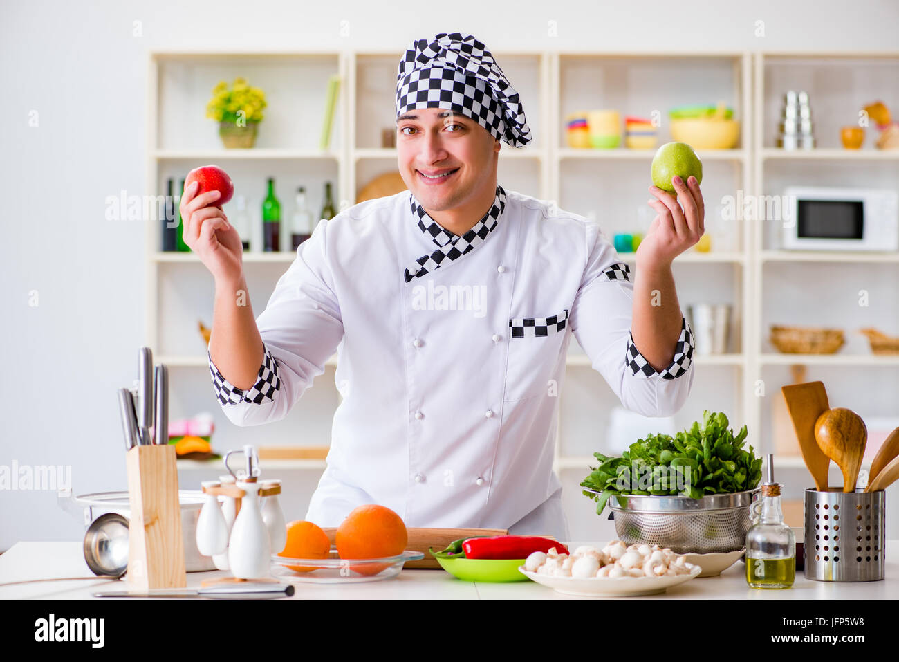 The young male cook working in the kitchen Stock Photo - Alamy