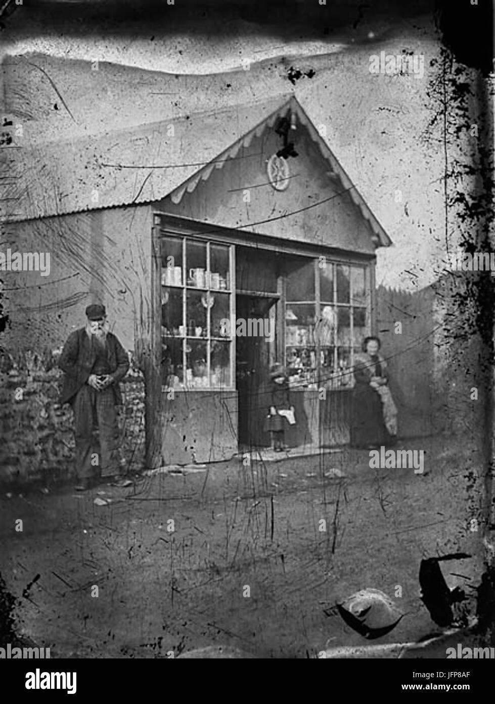 A man child and woman standing outside a shop NLW3365044 Stock Photo ...
