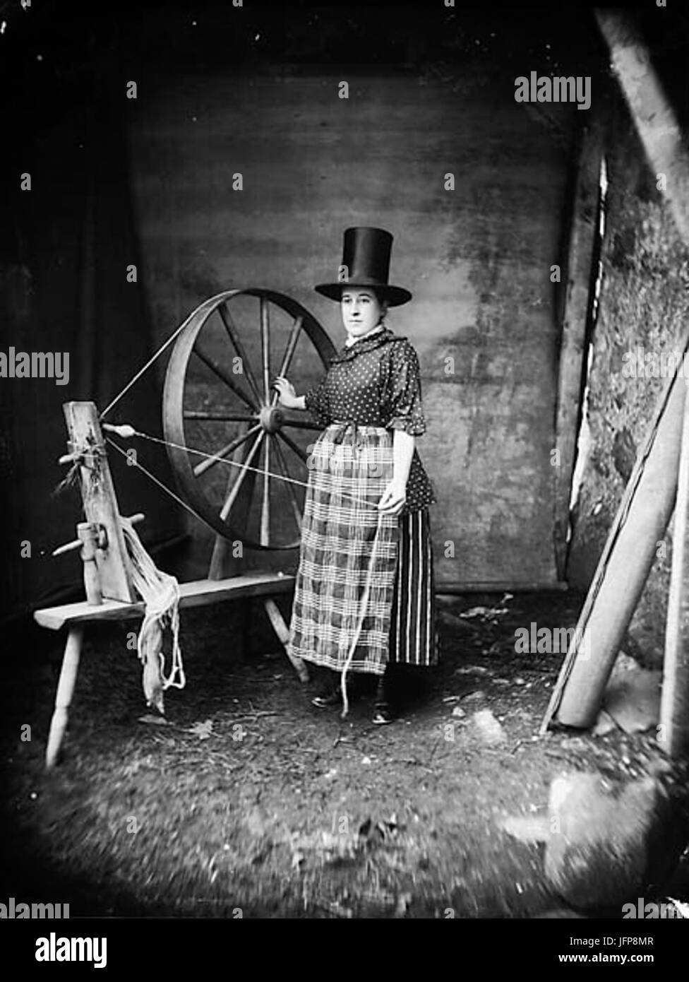 A woman in Welsh national dress with a spinning wheel NLW3361179 Stock ...