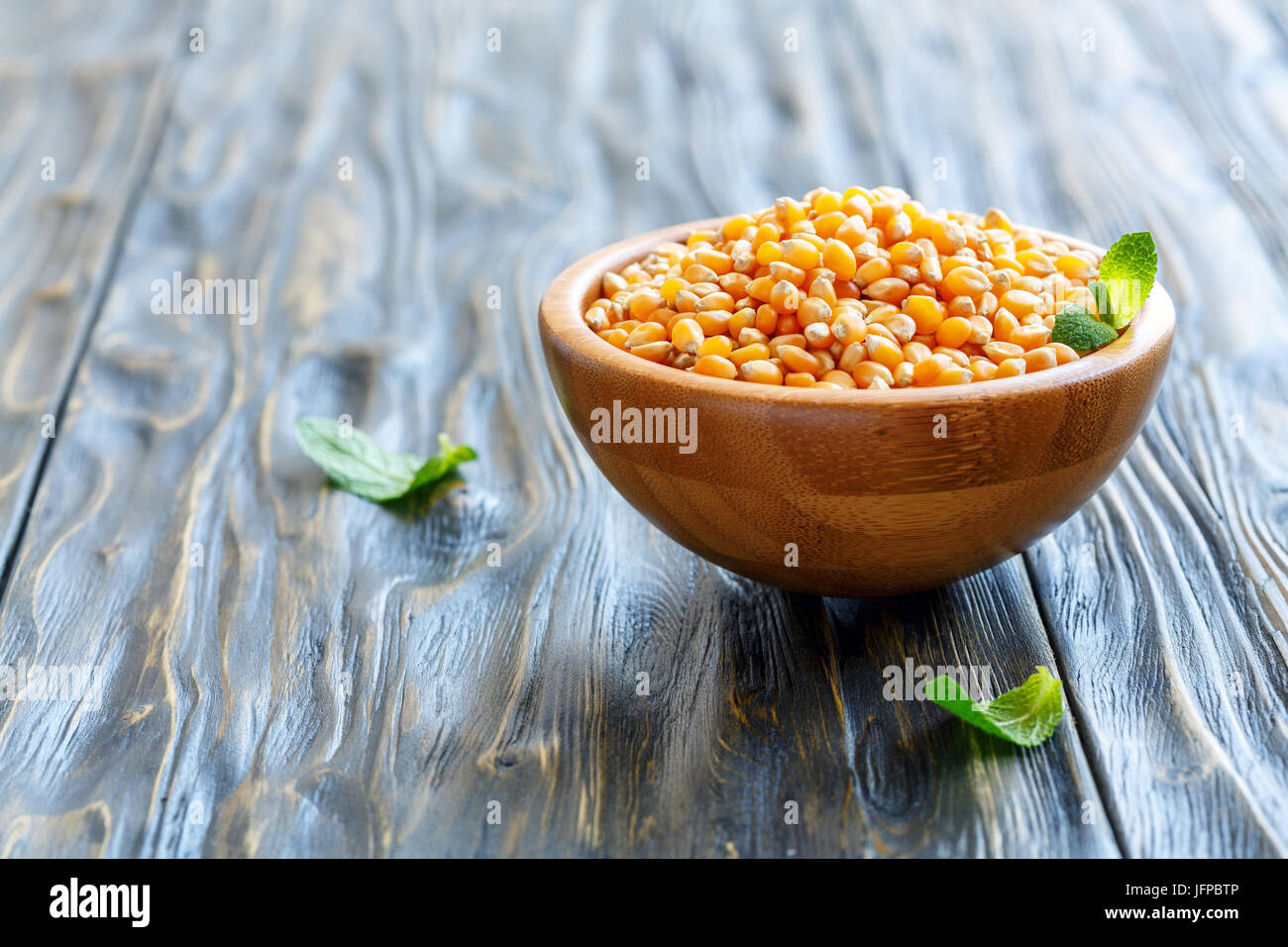 Dry corn for popcorn in a wooden bowl Stock Photo - Alamy