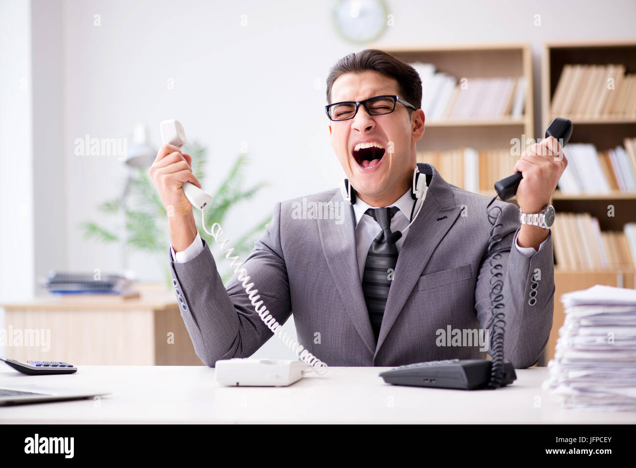 Angry helpdesk operator yelling in office Stock Photo - Alamy